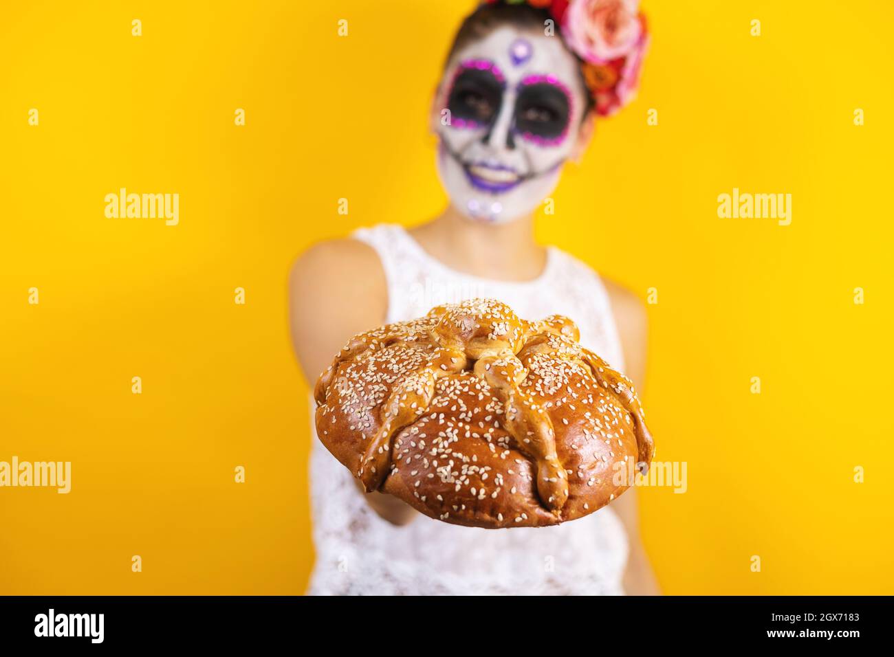 Mexican Catrina, portrait of young latin woman holding mexican hojaldra ...