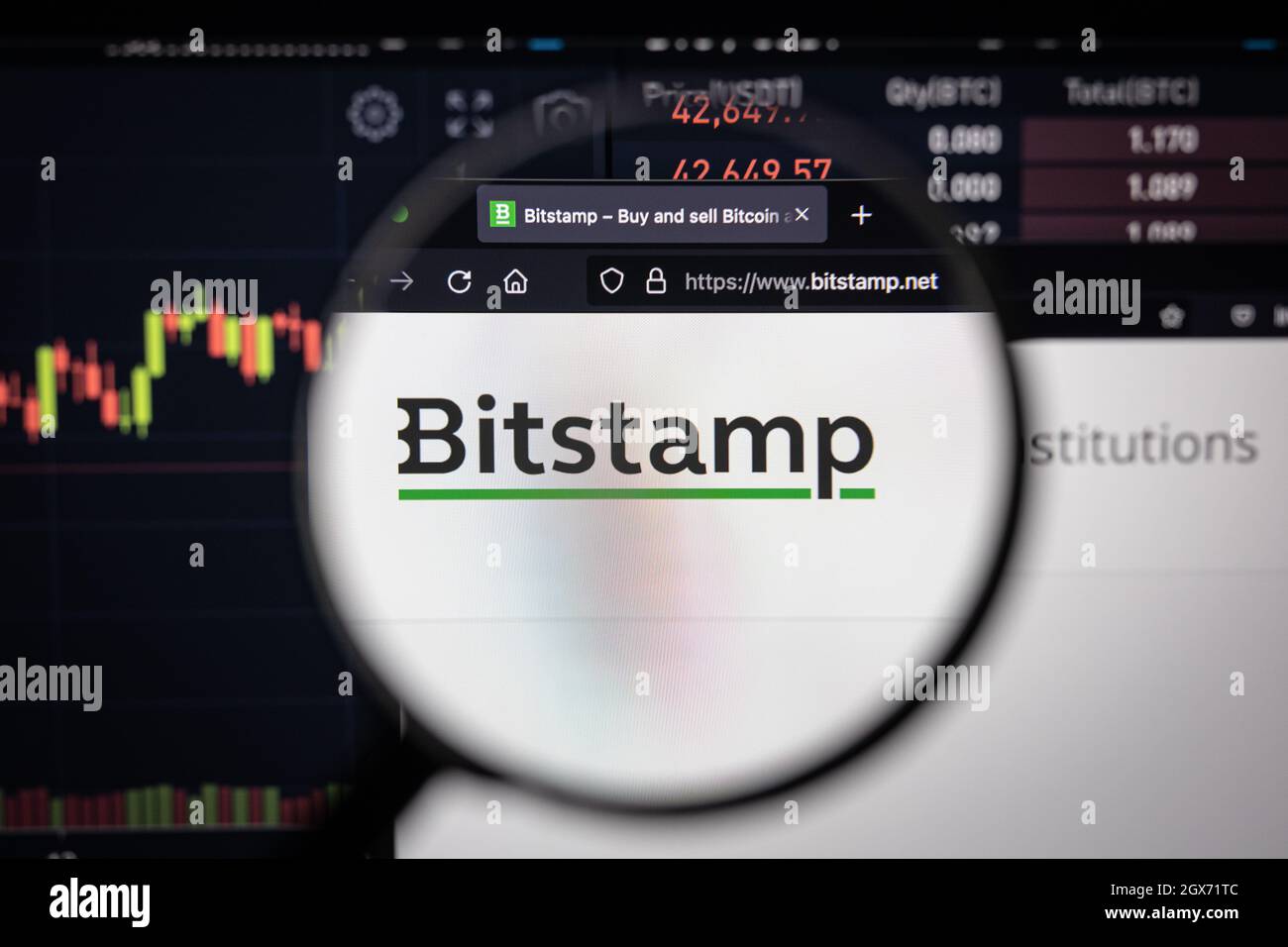 Bitstamp crypto exchange logo on a website with blurry stock market ...