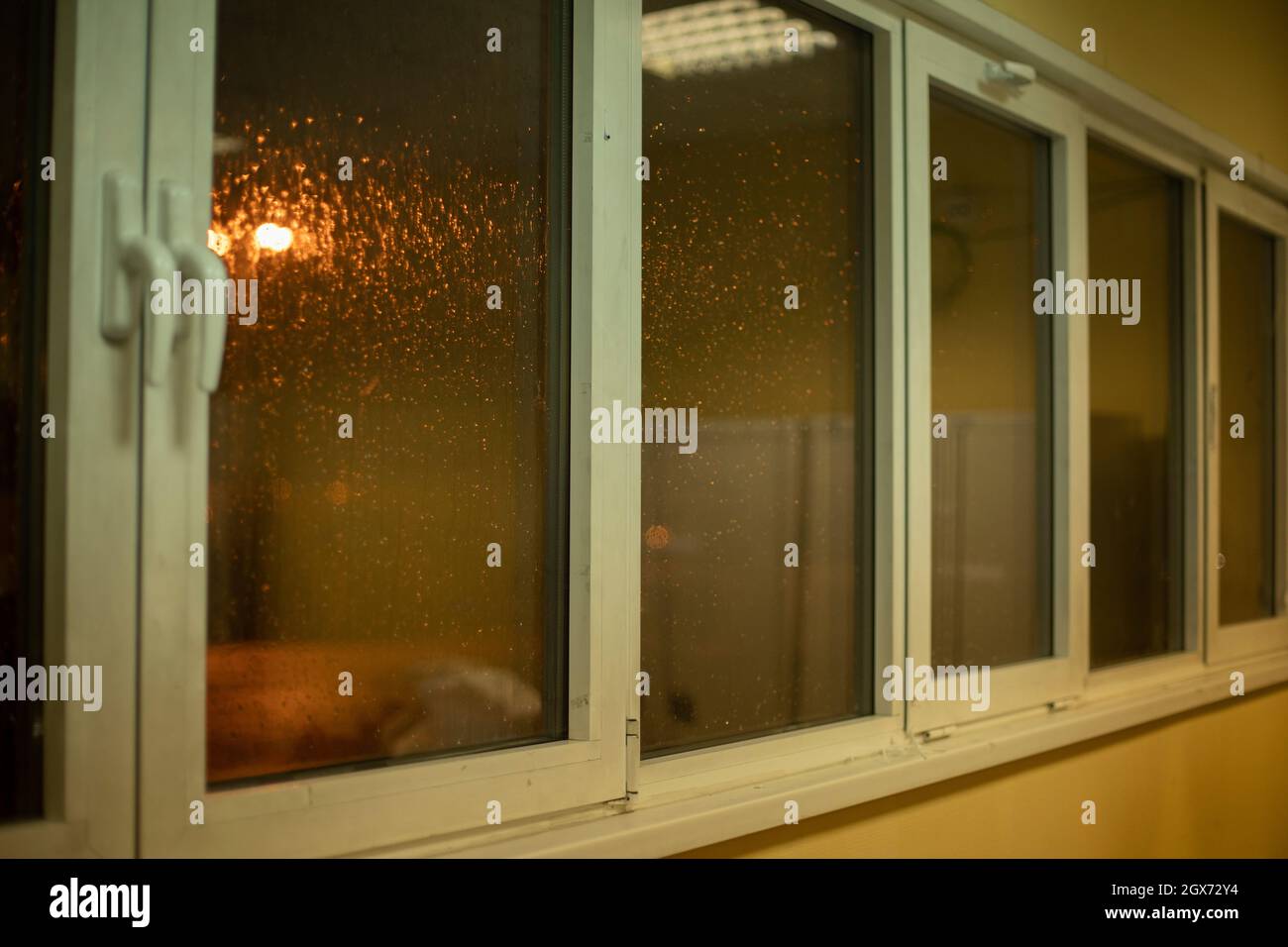 Plastic windows in the evening. Wet glass in the interior. Office ...