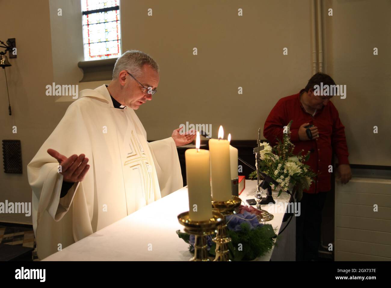 Man praying in front of cross hi-res stock photography and images - Alamy