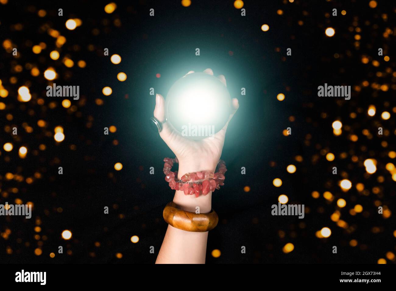 Fortune teller or witch hand and a glowing magic ball. Halloween, magic ...