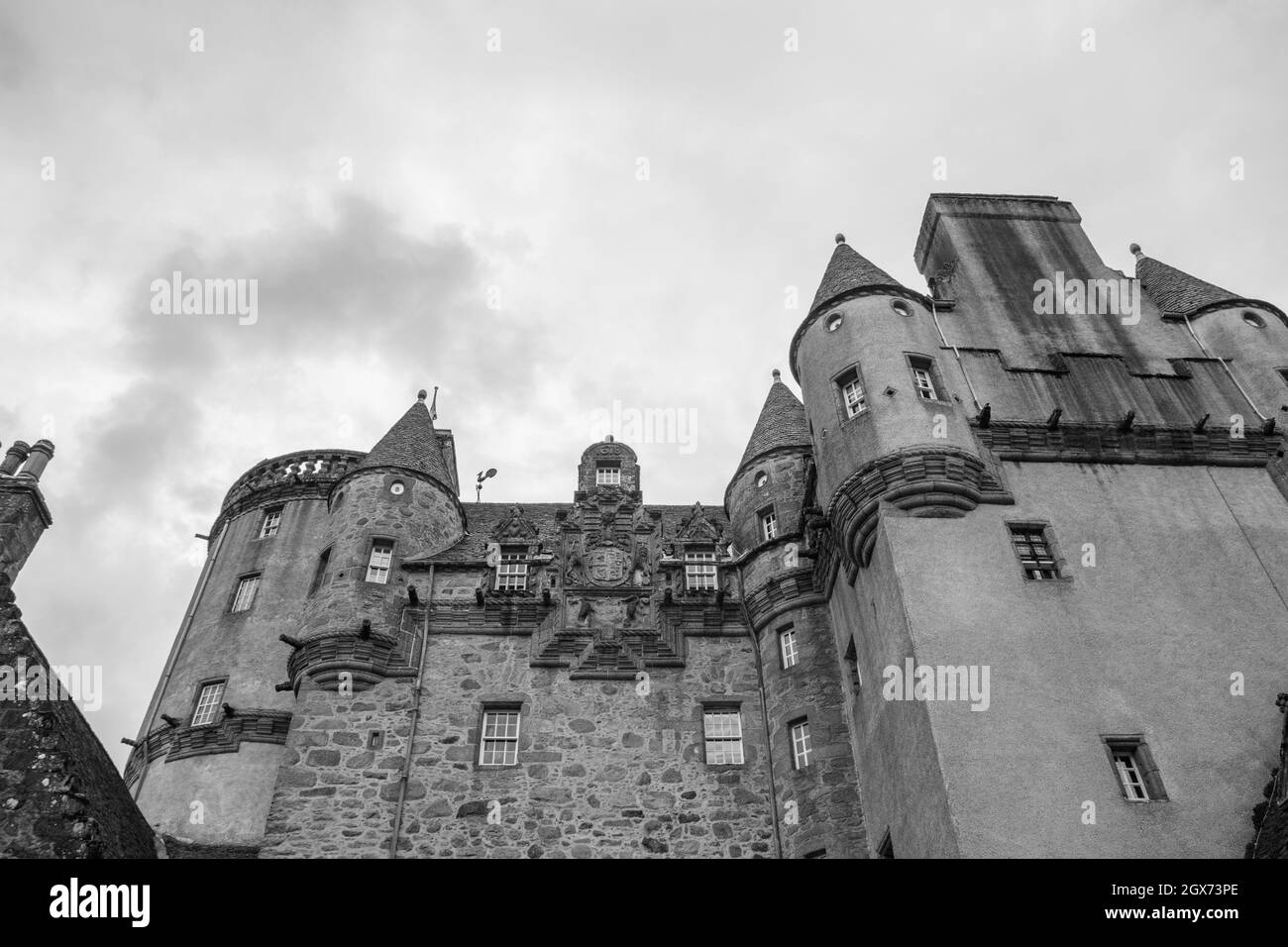 Grayscale low-angle shot of the famous historic Z-plan Castle Fraser ...