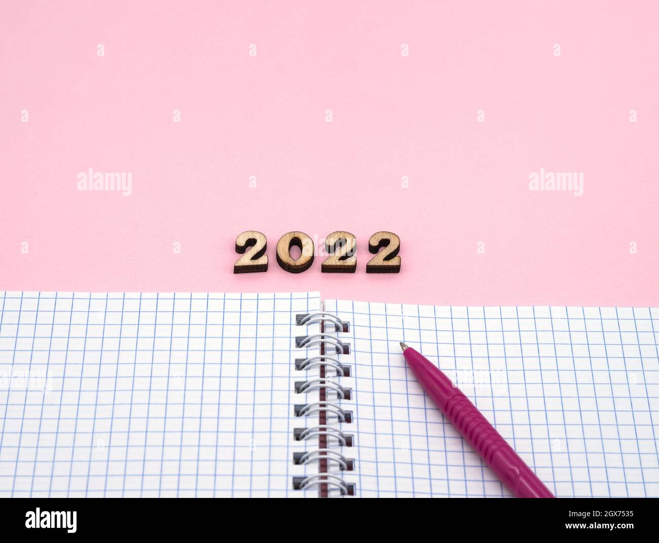 Wooden numbers 2022. Notepad on a spring. Notepad and Pen on Pink. Pink ...