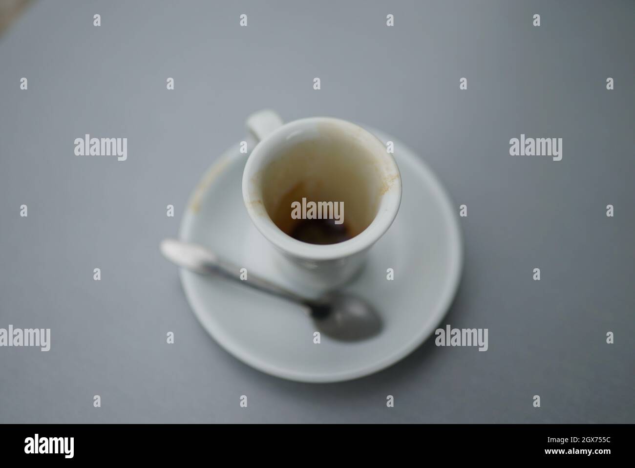 Empty small coffee cup with a spoon Stock Photo - Alamy
