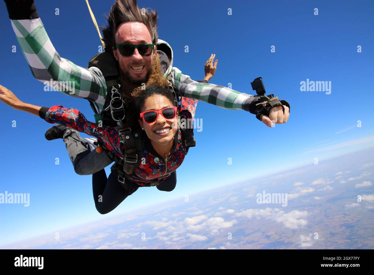 Tandem parachute jump. Beautiful Brazilian woman Stock Photo - Alamy