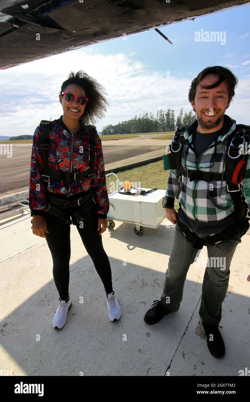 Tandem parachute jump. Beautiful Brazilian woman Stock Photo - Alamy