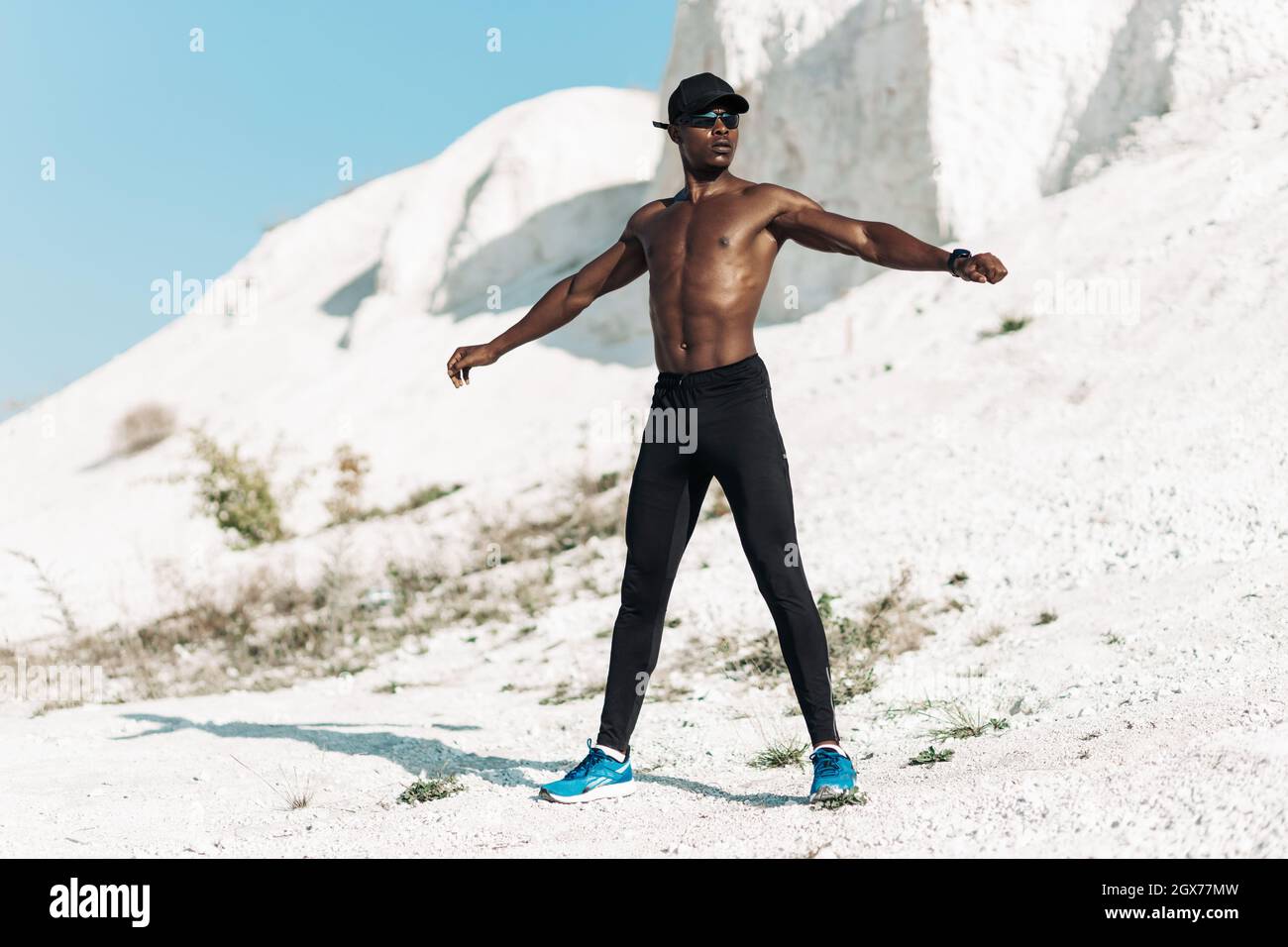 Muscular African American man doing stretching and getting ready for ...