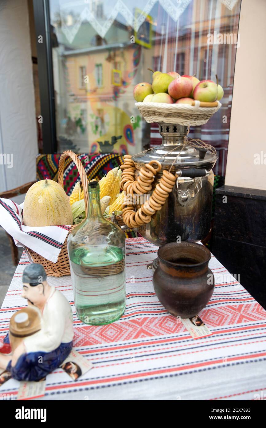 Table decoration - a bottle of Ukrainian vodka, a samovar, a basket of ...