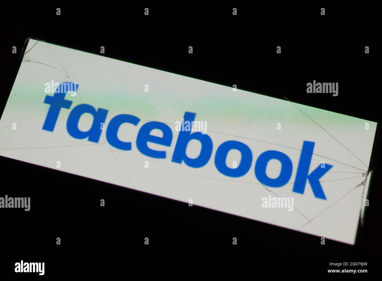 In this photo illustration facebook logo seen displayed on a broken ...