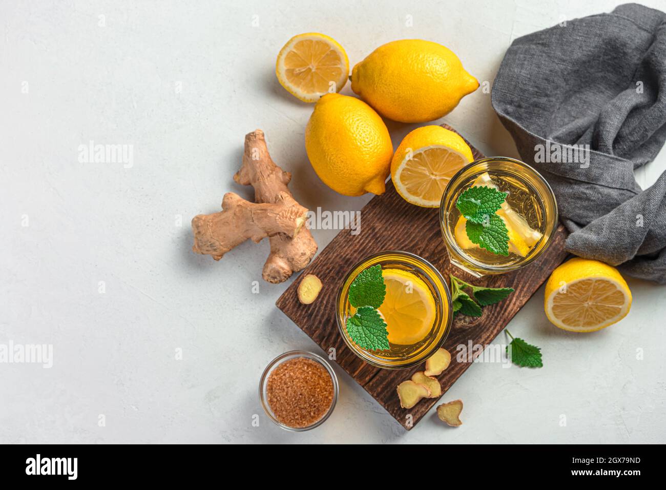 Ginger tea with lemon and mint on a gray background. A useful, immuno ...
