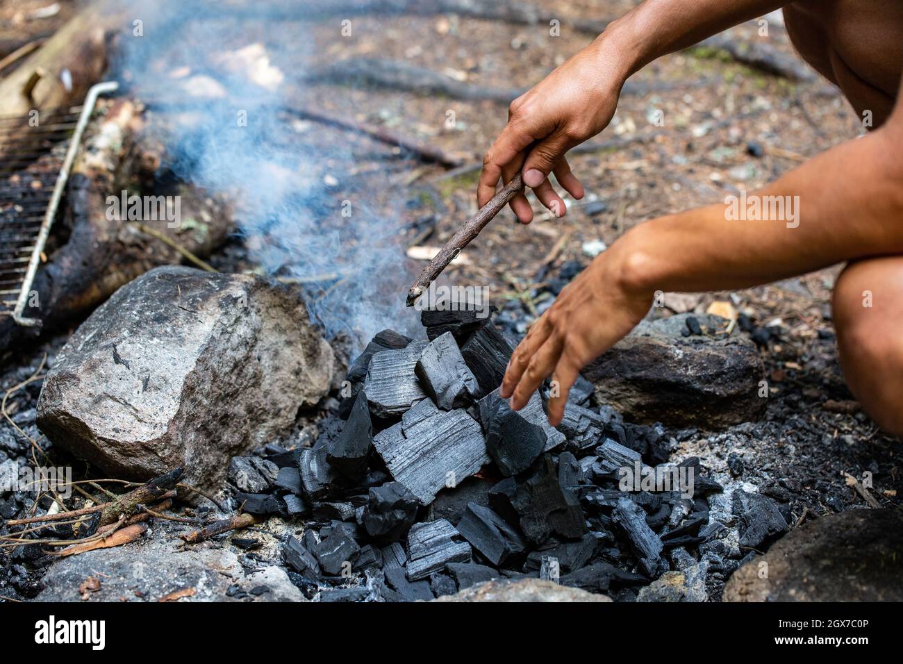 Man making a bonfire on a camp Stock Photo - Alamy