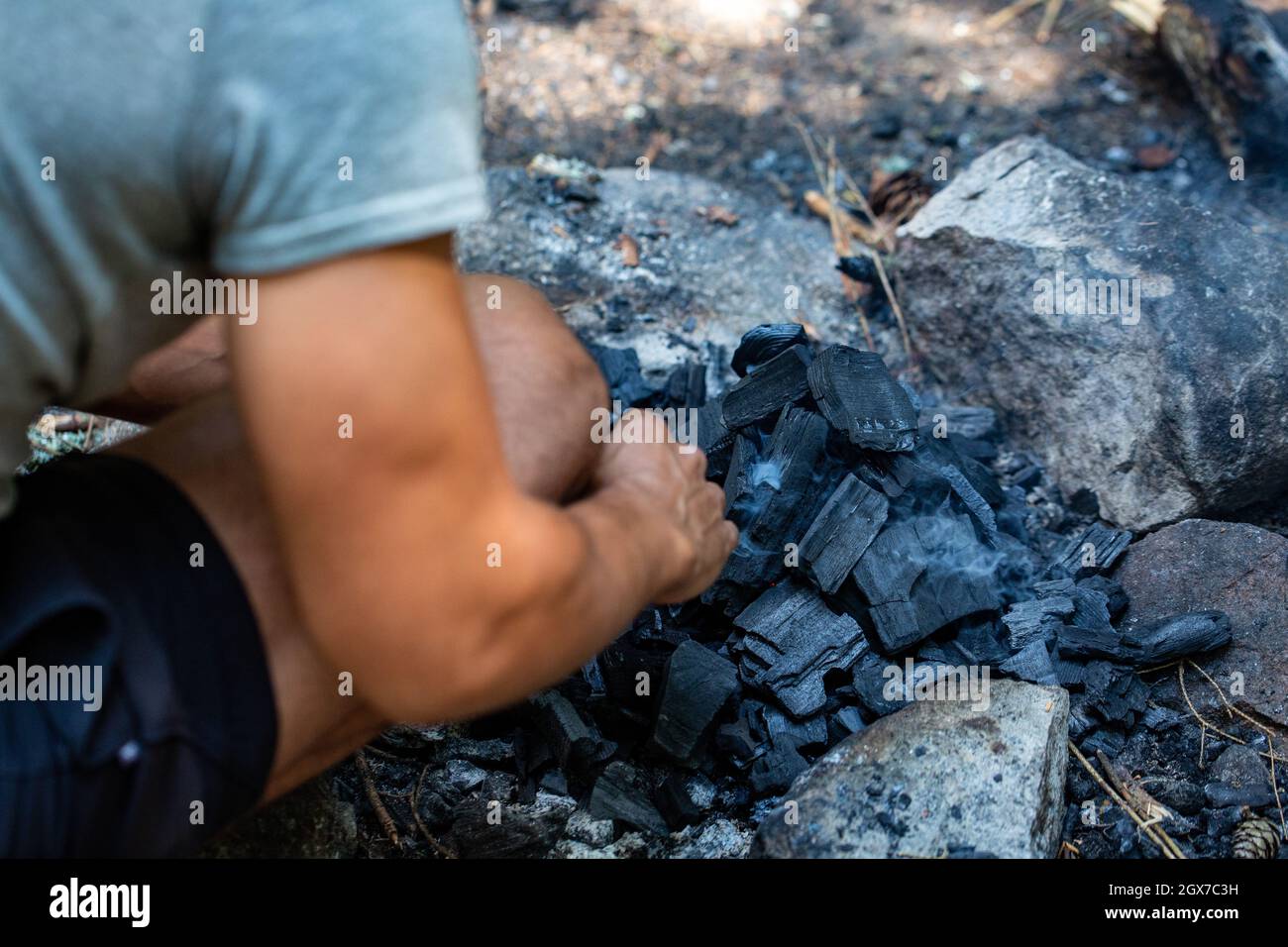 Man making a bonfire on a camp Stock Photo - Alamy