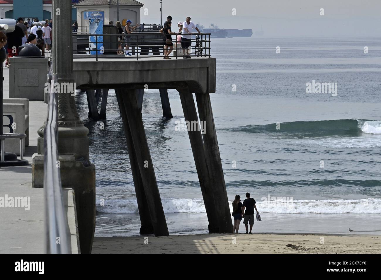 Huntington Beach, United States. 04th Oct, 2021. Beachgoers walk up to ...