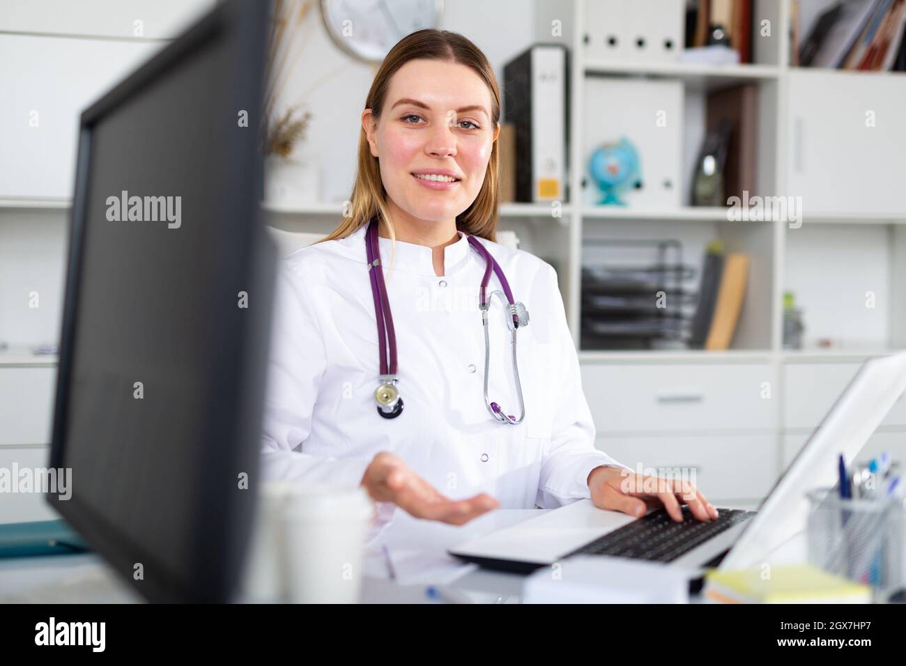 Doctor working effectively in her office Stock Photo - Alamy