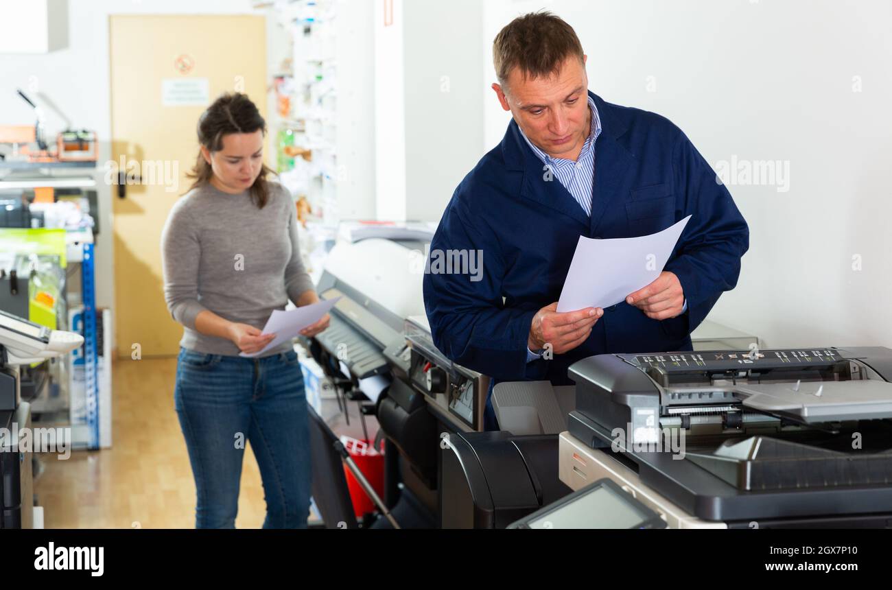 Printing company employees work on various printing machines Stock ...