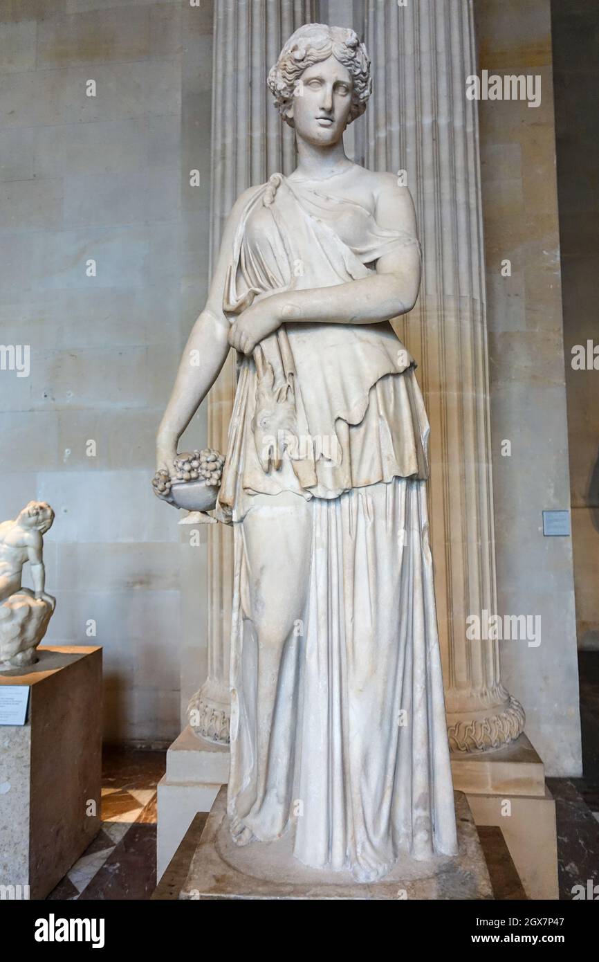 Greek female statue holding grapes at the Louvre in Paris, France Stock ...