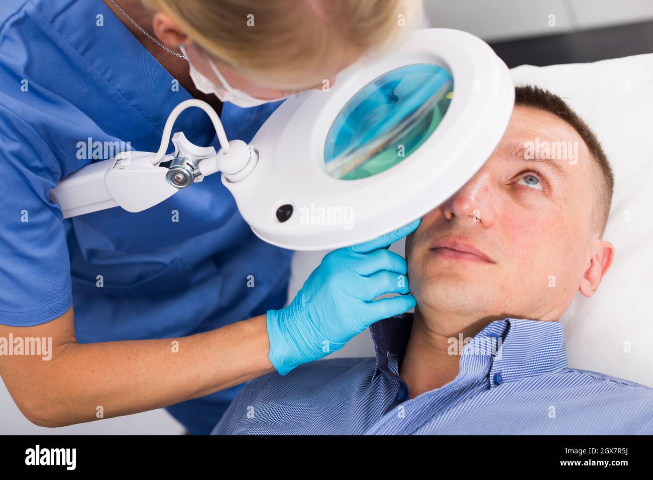 Female doctor is doing cleaning skin procedure to client Stock Photo ...