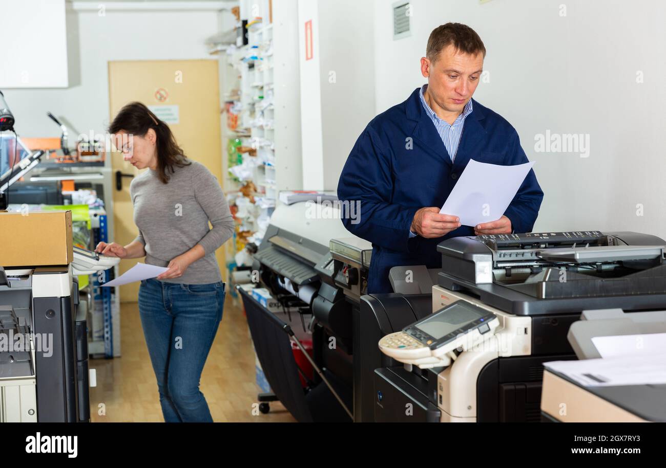 Printing company employees work on various printing machines Stock ...