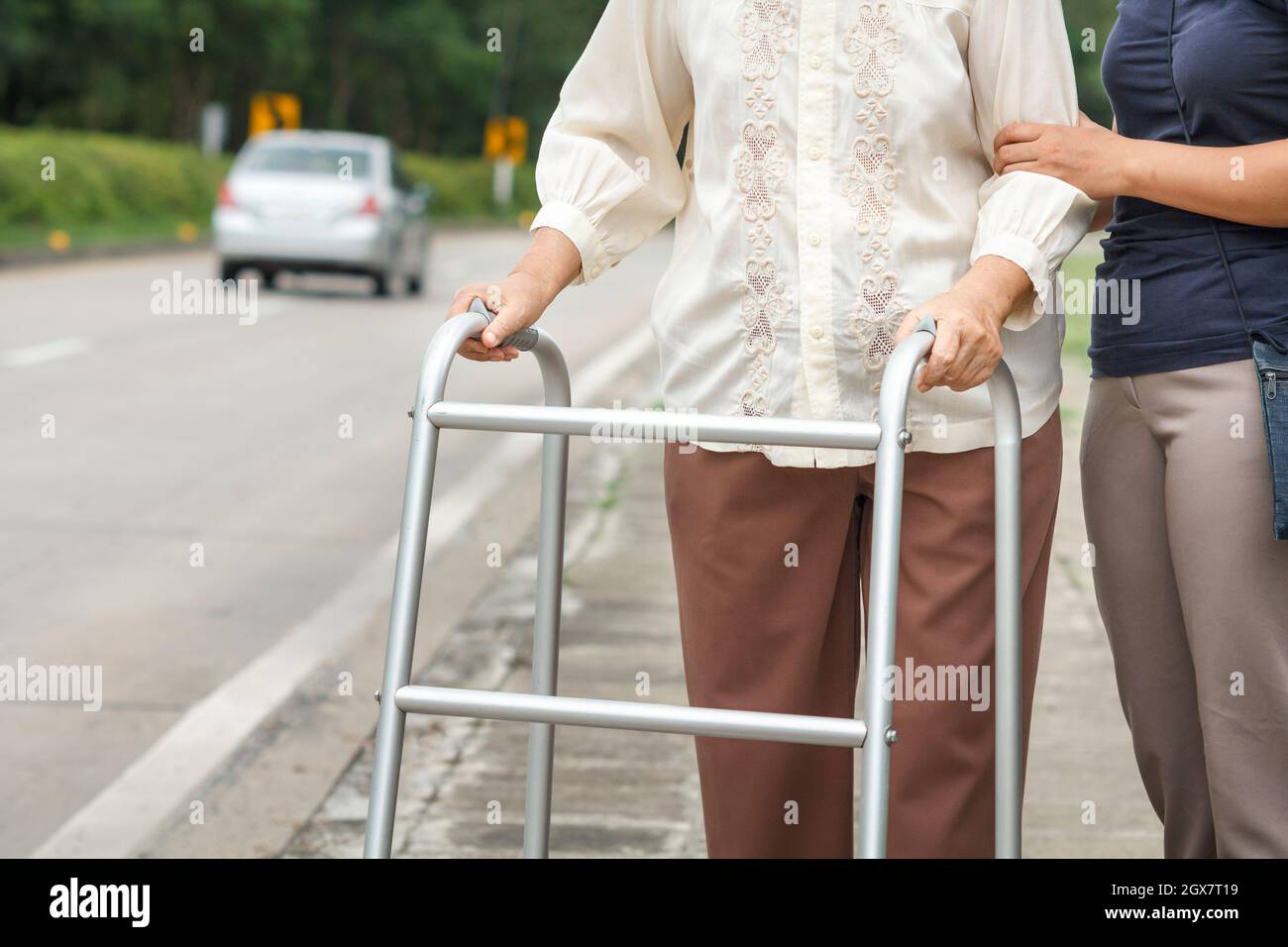 senior woman using a walker cross street Stock Photo - Alamy