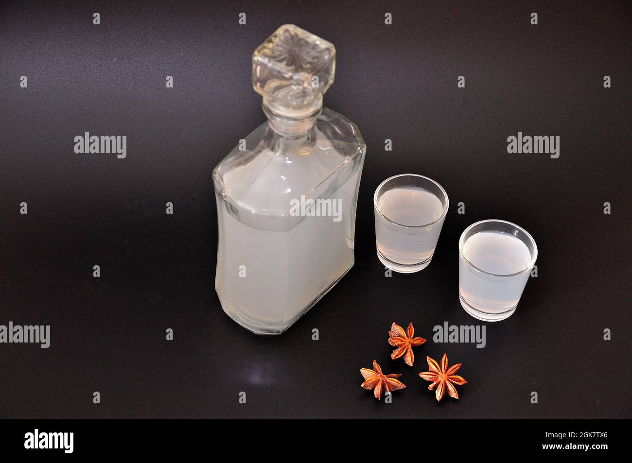 Anise brandy, homemade strong alcohol with a glass bottle and two ...