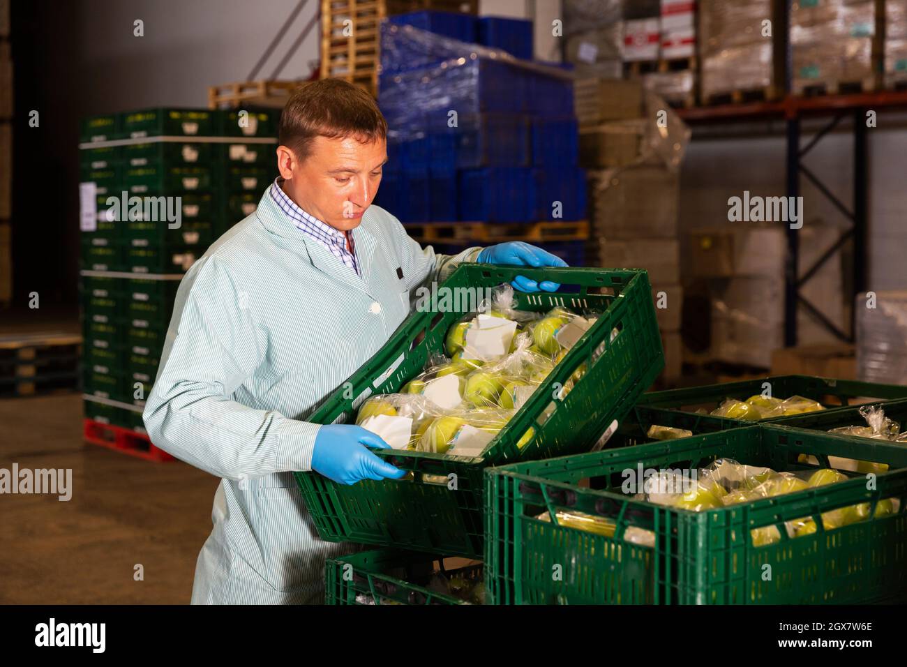 Focused man stacking boxes hi-res stock photography and images - Alamy