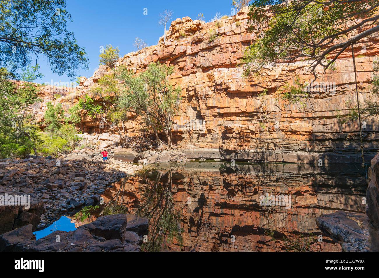 Spectacular red cliffs of The Grotto reflected in the water, near ...