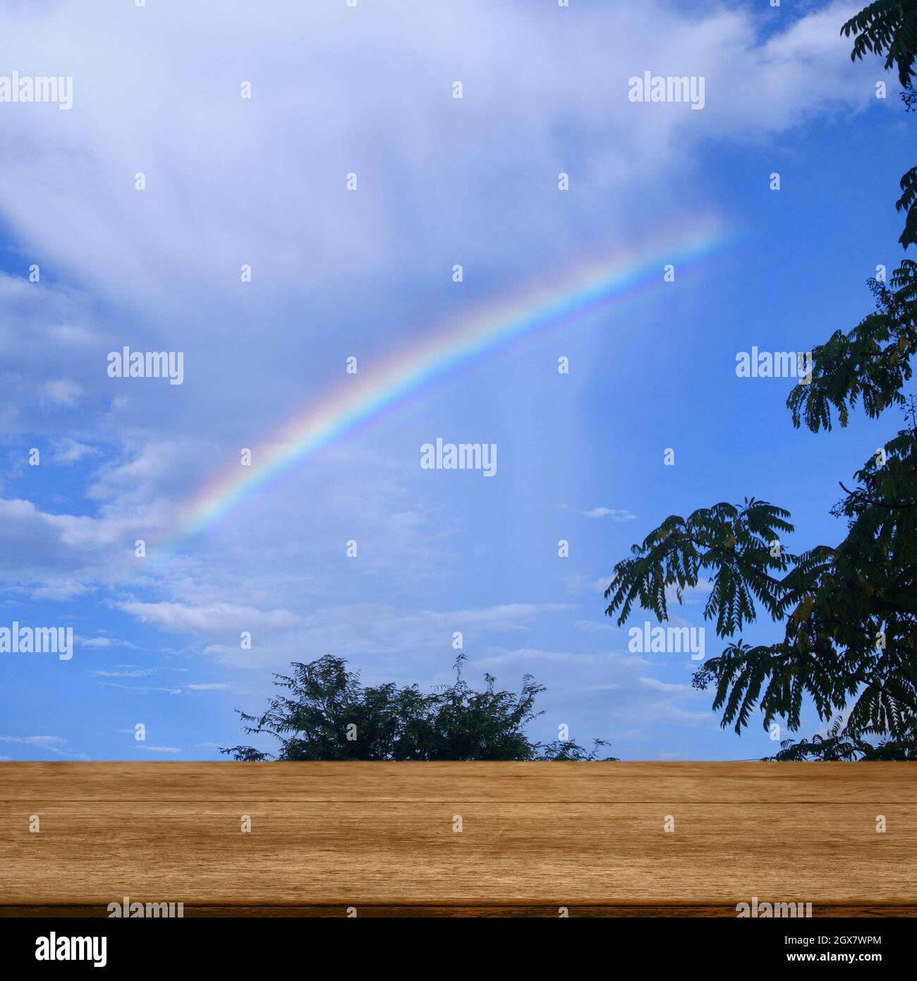 Empty wooden table in front of rainbow background Stock Photo - Alamy