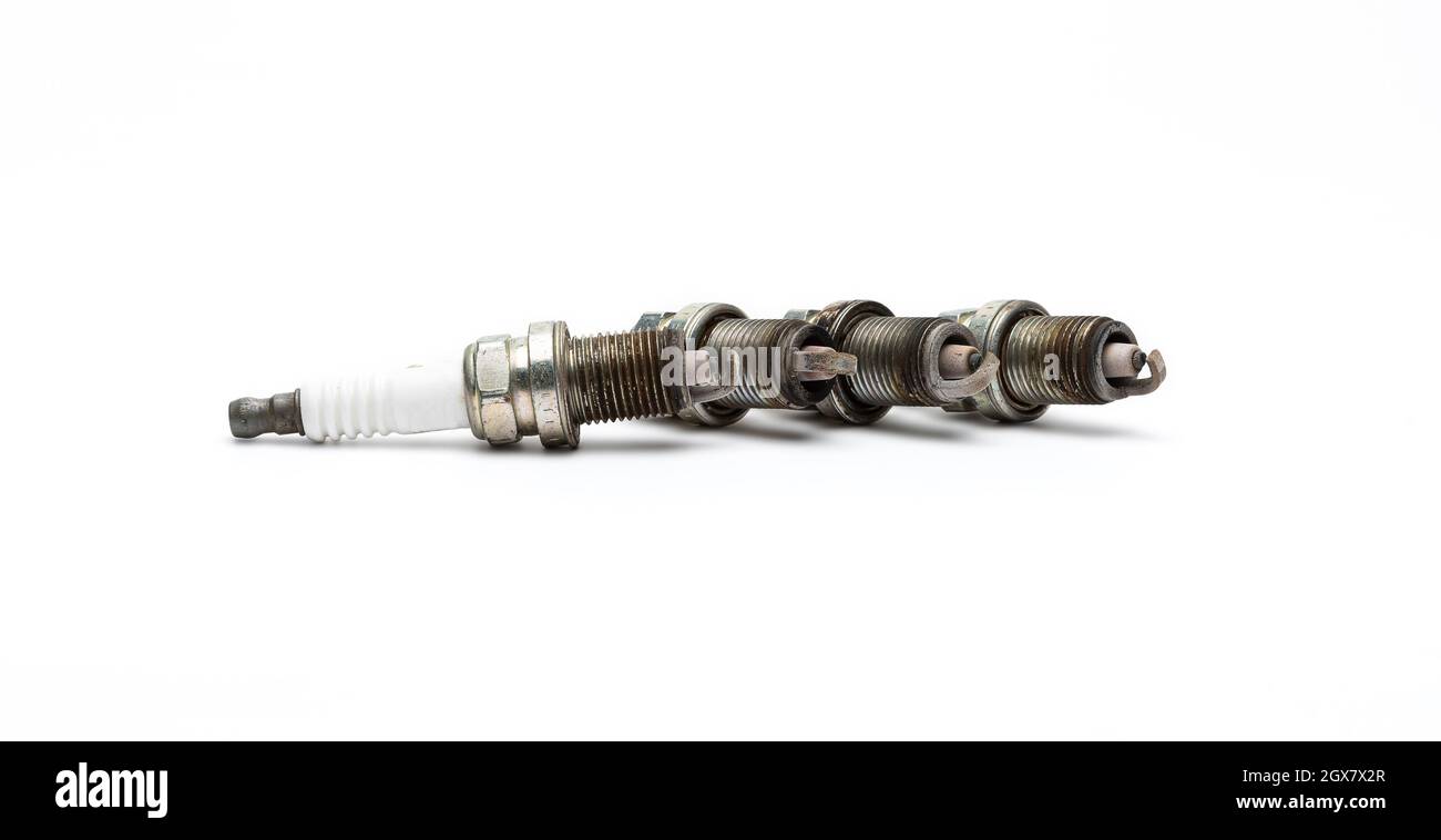 Close up four used spark plugs isolated on white background Stock Photo ...