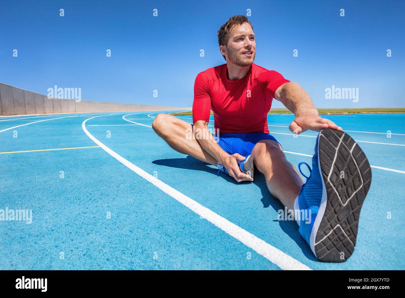 Man runner stretching legs preparing for run training on outdoor ...