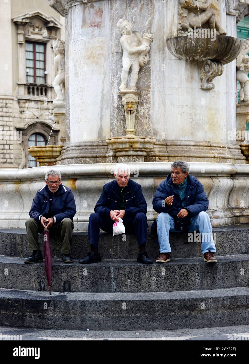 Sicilian men sitting beneath the Fuente del Elefante in the Piazza Del ...