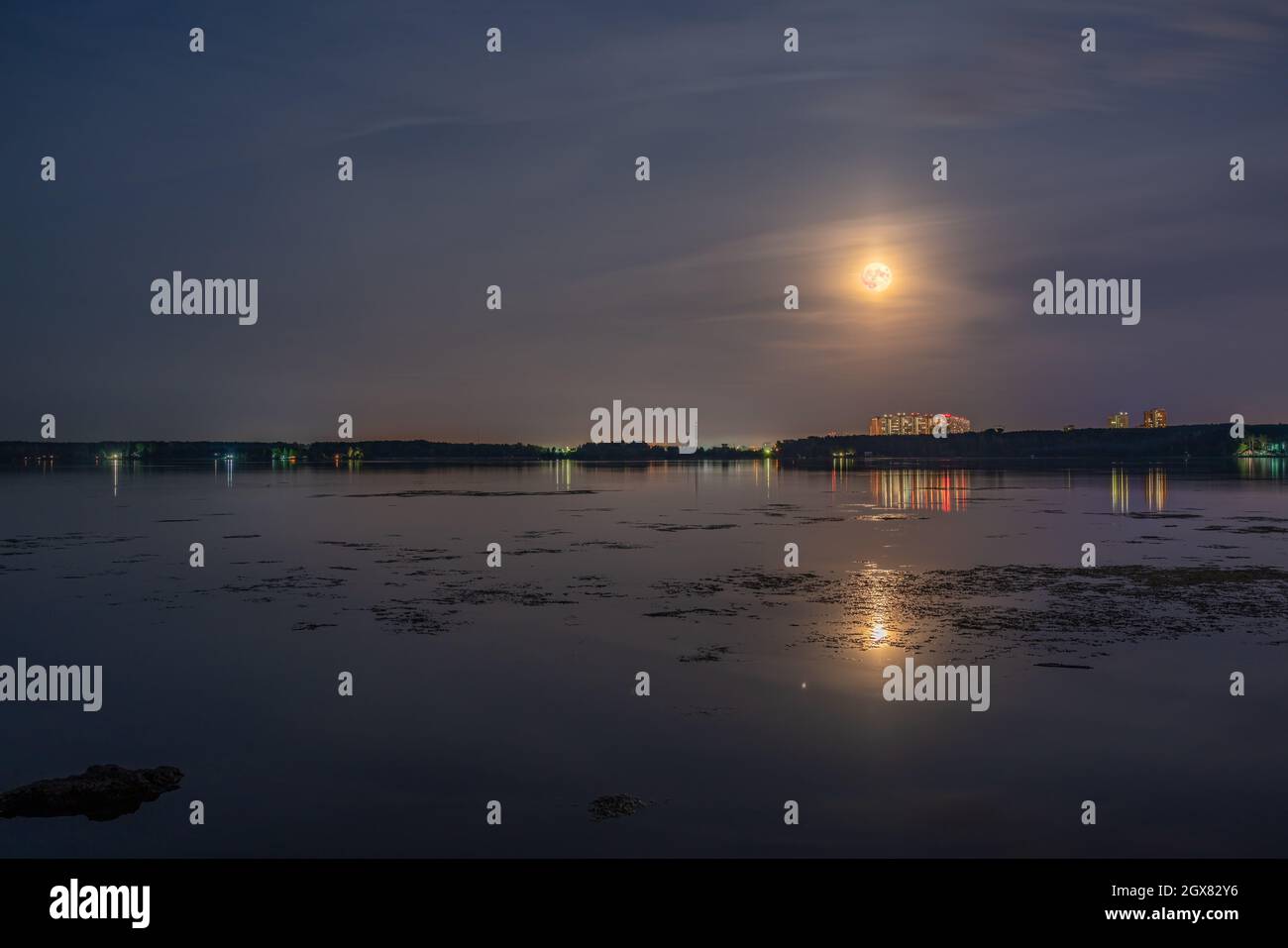 Super full blood moon and moon light over the nigt lake. Full red moon ...