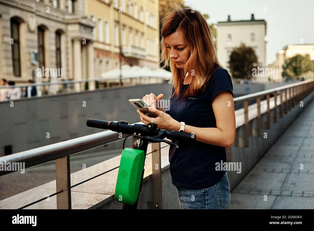 Woman unlock electric scooter for rent using mobile phone app. Modern ...