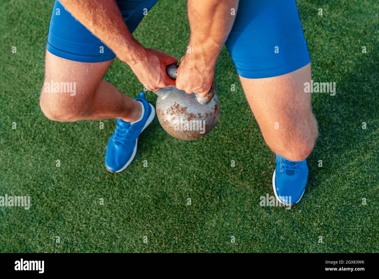 Kettlebell weightlifting man lifting crossfit weight at outdoor gym ...
