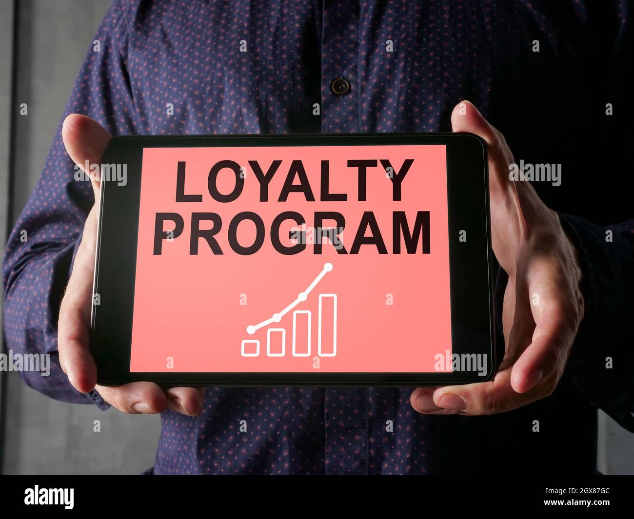 Man holds tablet with marketing data about loyalty program Stock Photo ...
