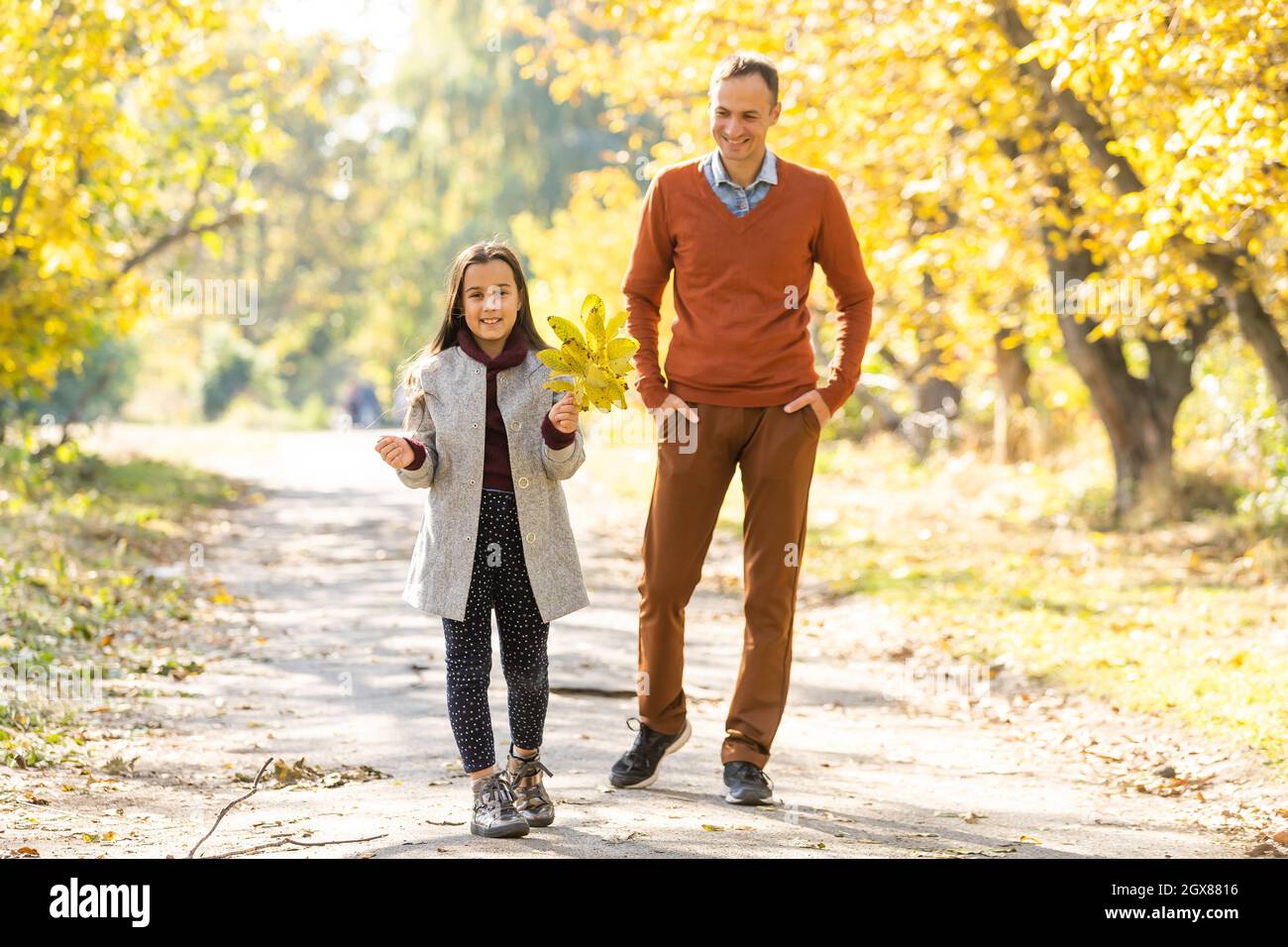 Happy father with daughter in fall season Stock Photo - Alamy