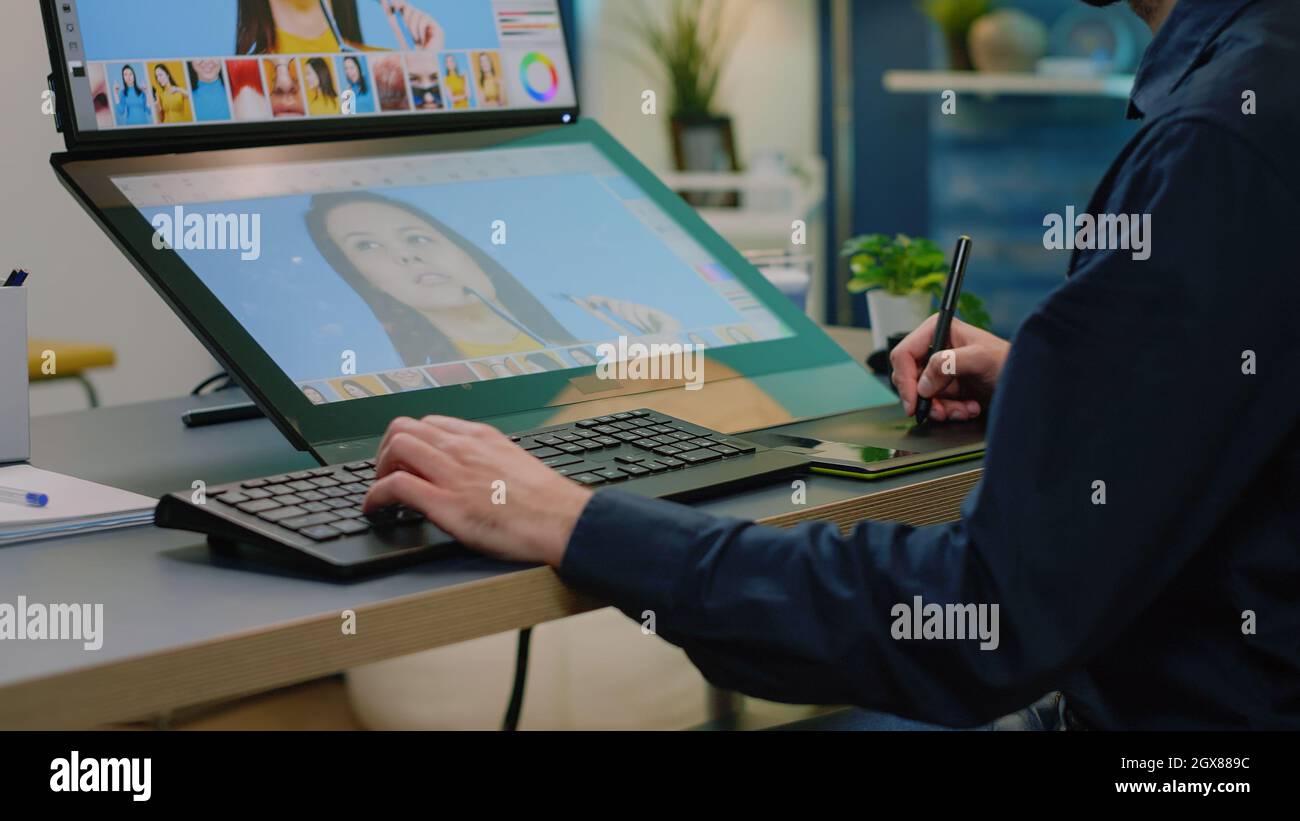 Close up of photographer hands using retouching software on touch ...
