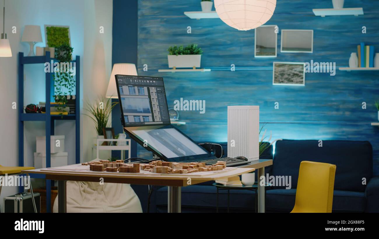 Man architect using touch screen monitor with building model on display ...