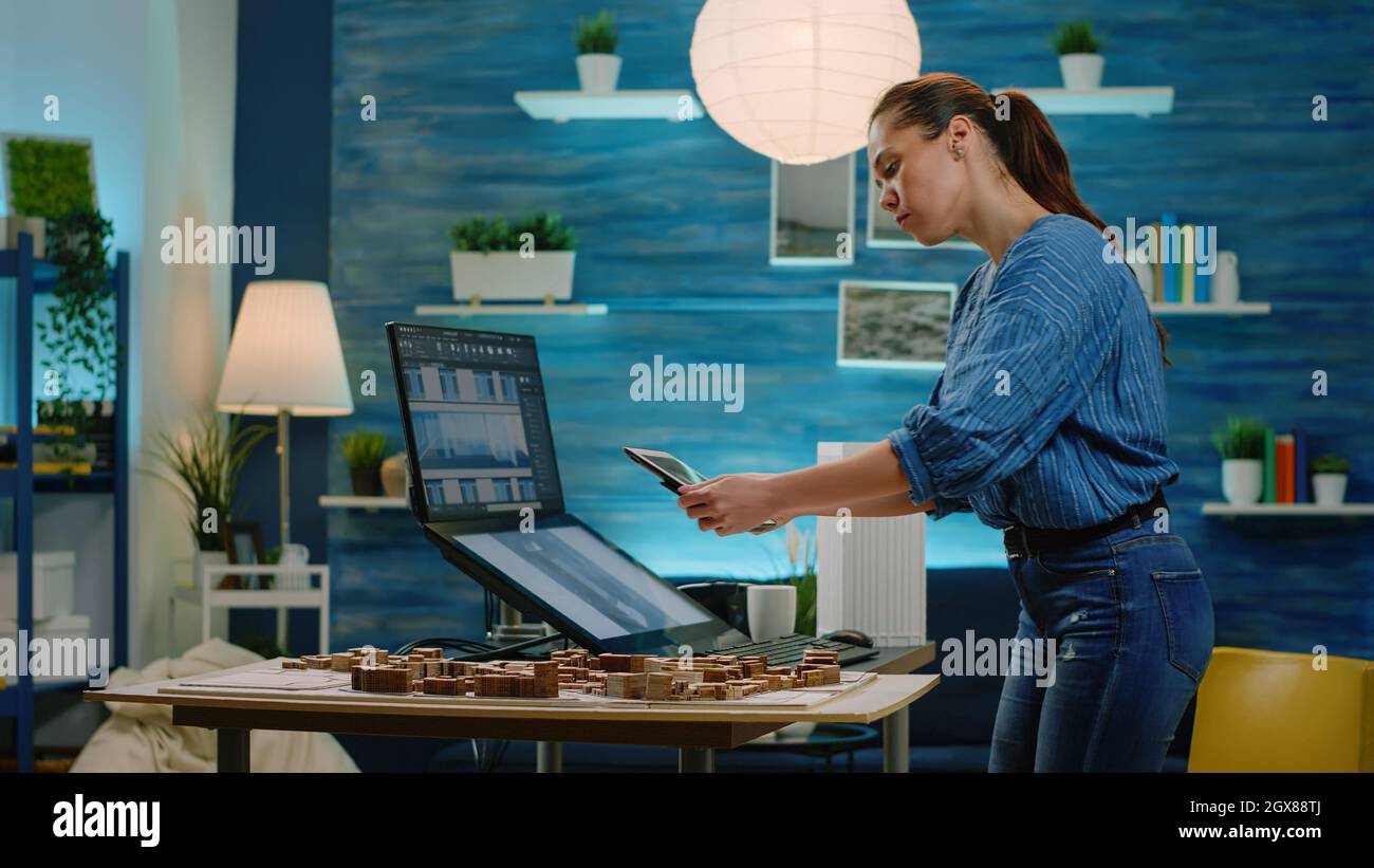 Woman Architect Analyzing Building Model On Tablet And Computer For Construction Development