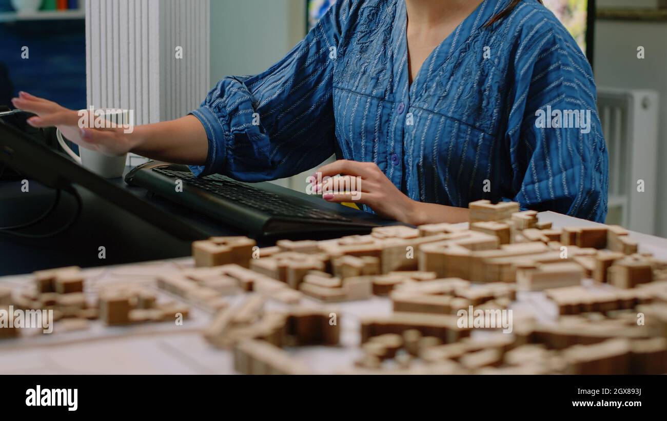 Close Up Of Architectural Desk With Building Model And Computer With Touch Screen Architect