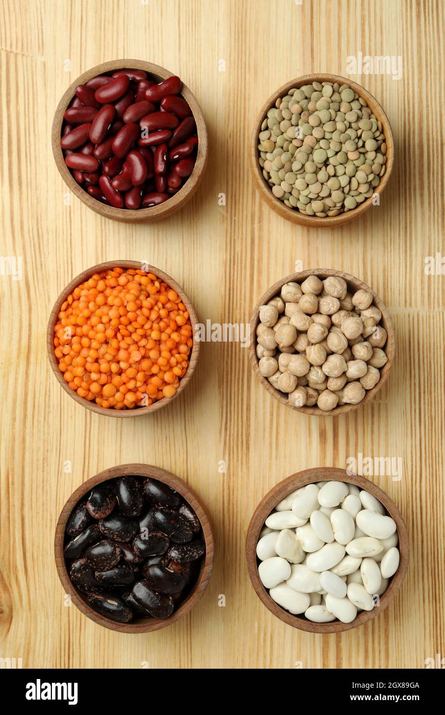 Flat lay composition with different types of beans on a wooden ...