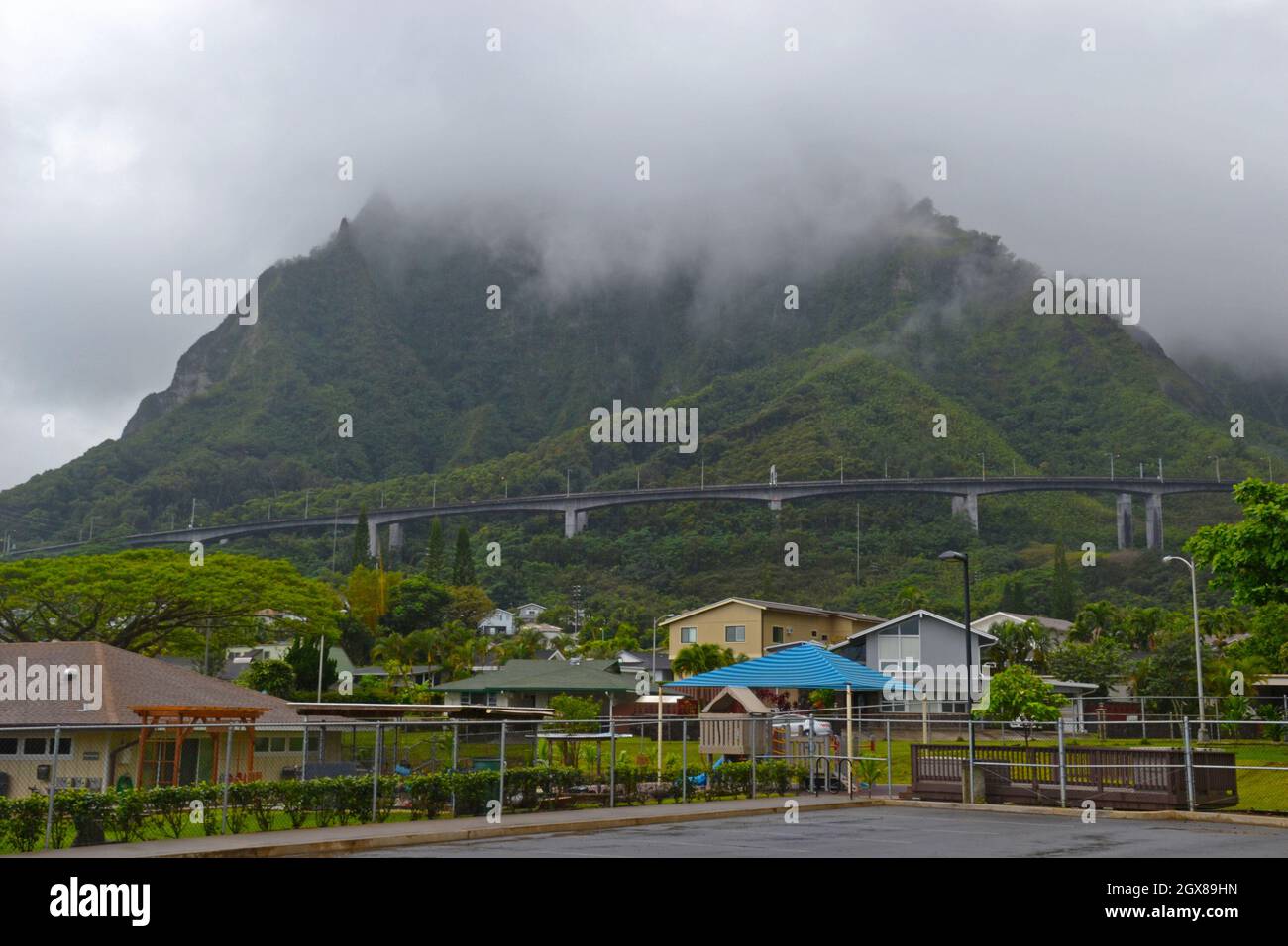 Windward Oahu neighborhood with a view of the Koolau mountains and H3 ...