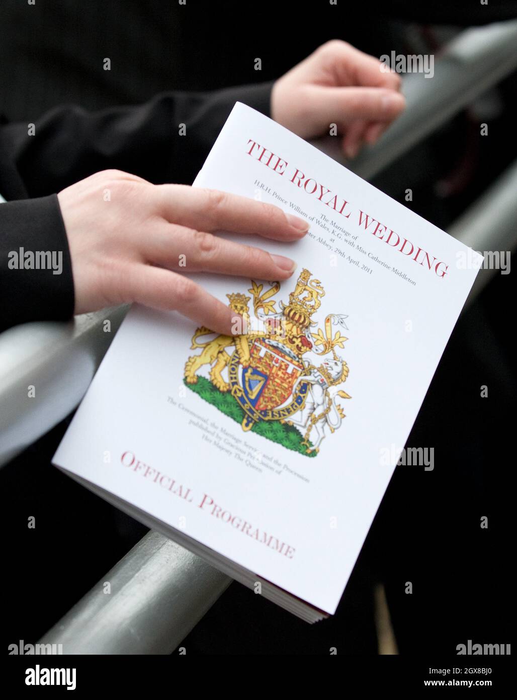 A guest holds the Order of Service programme for the Wedding of Prince ...