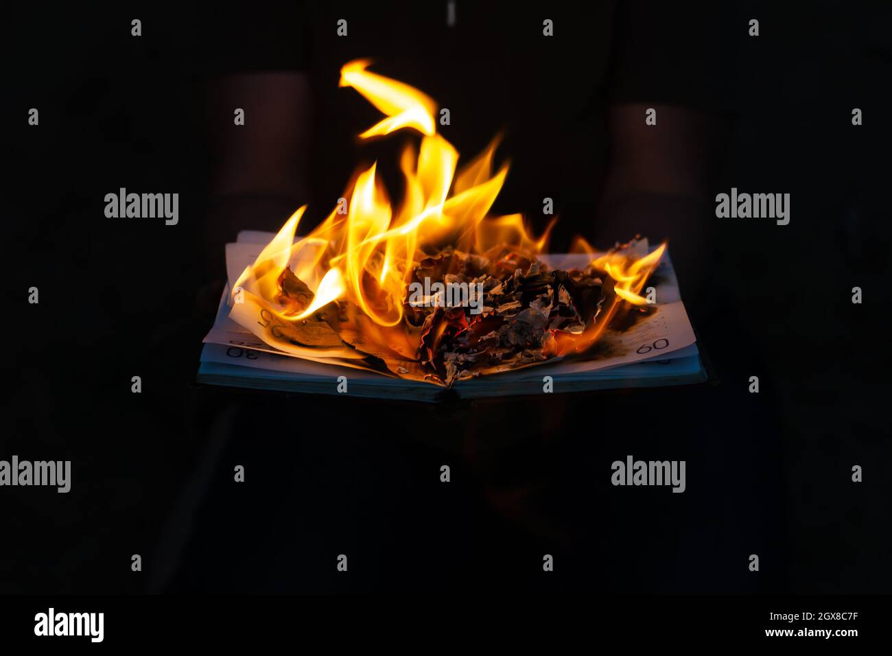 Open burning diary on black background. Notebook with flame coverage ...