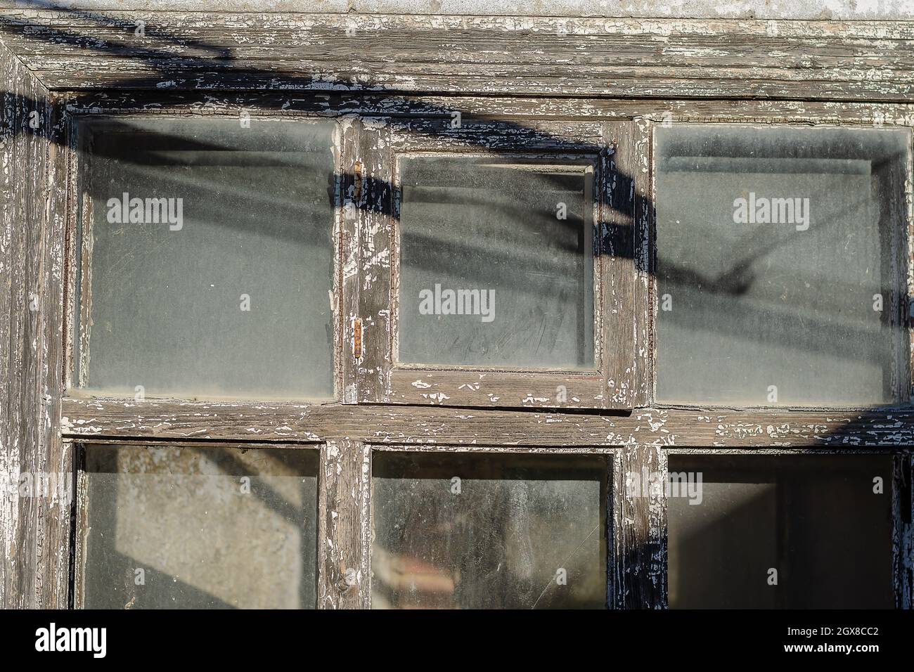 An old wooden window with dusty panes. The facade of an abandoned ...