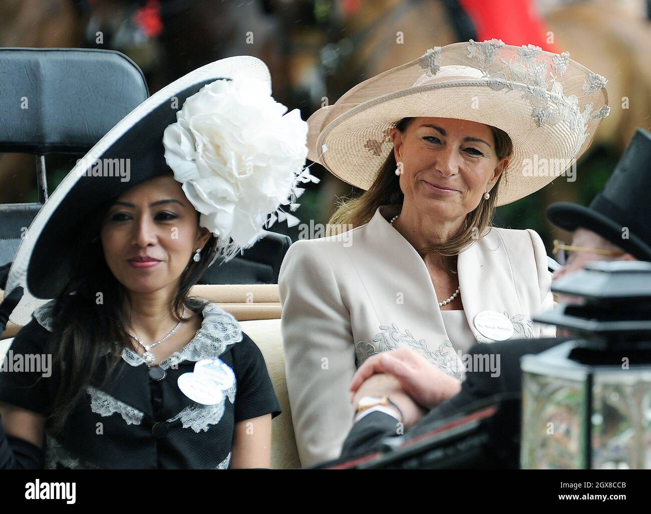 Carole Middleton and Fitri Hay (left) take part in the traditional ...