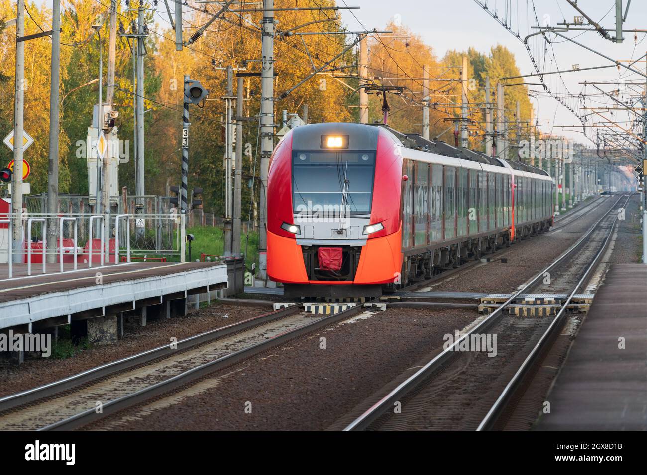 Modern intercity high speed train at sunset. Commercial suburban ...