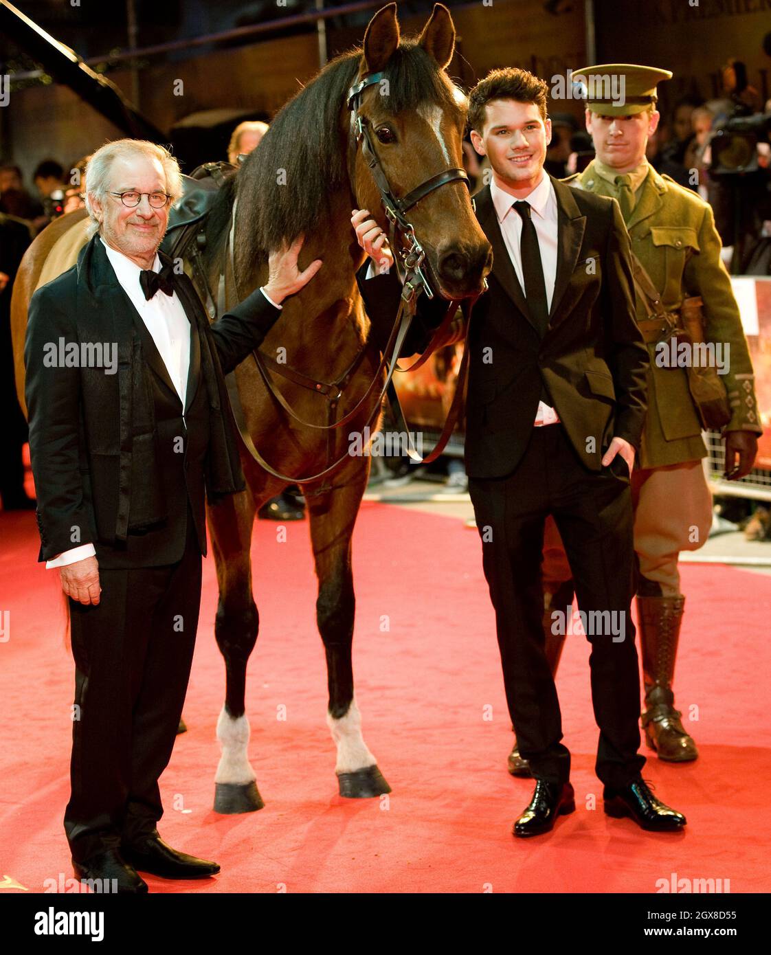 Director Steven Spielberg (L) and actor Jeremy Irvine pose with Joey ...