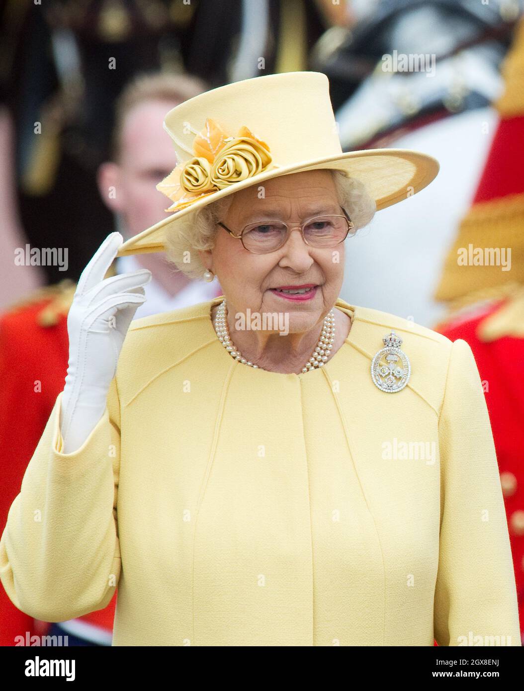Queen Elizabeth ll watches a march past outside Buckingham Palace ...