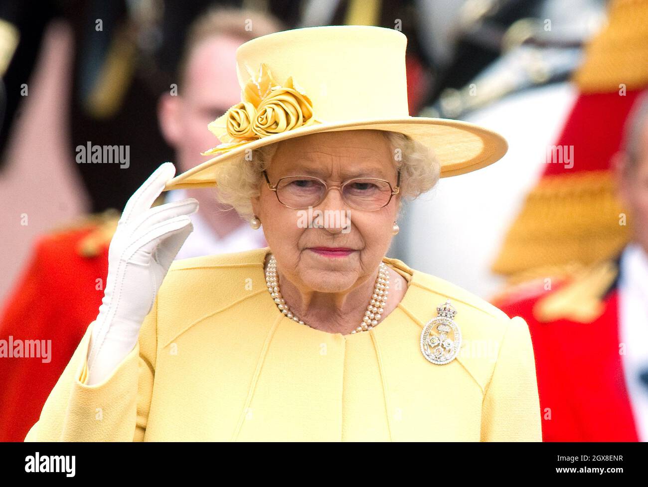 Queen Elizabeth ll watches a march past outside Buckingham Palace ...