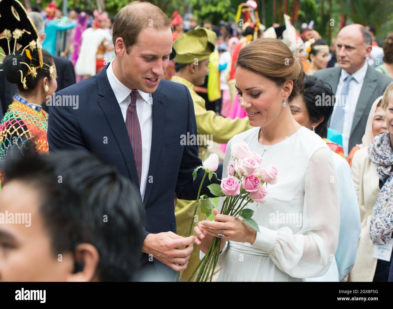 Catherine, Duchess of Cambridge smiles as she receives a bunch of roses ...